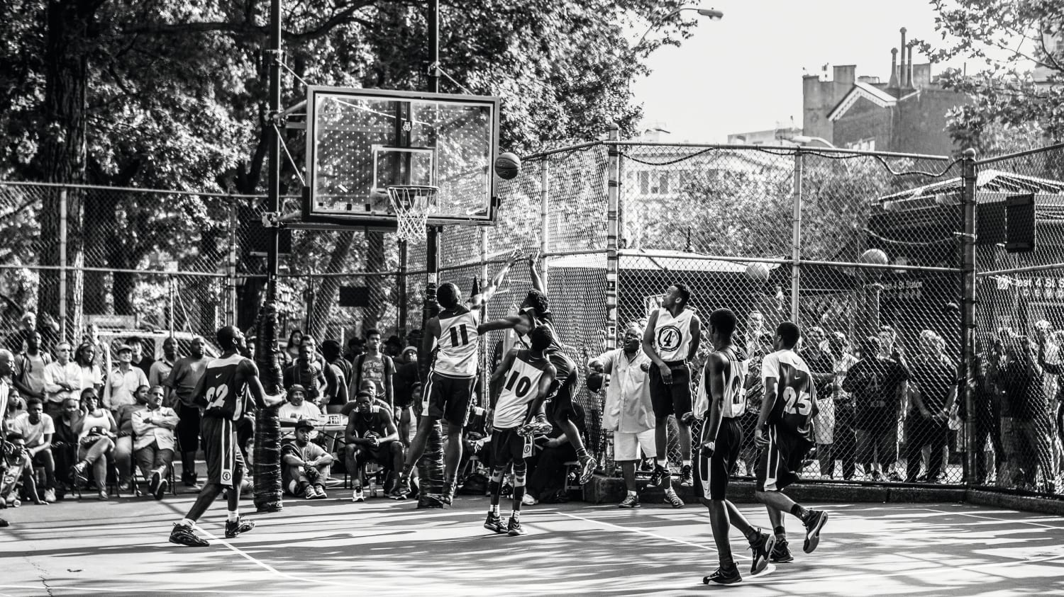 A community of people enjoying a game of basketball.
